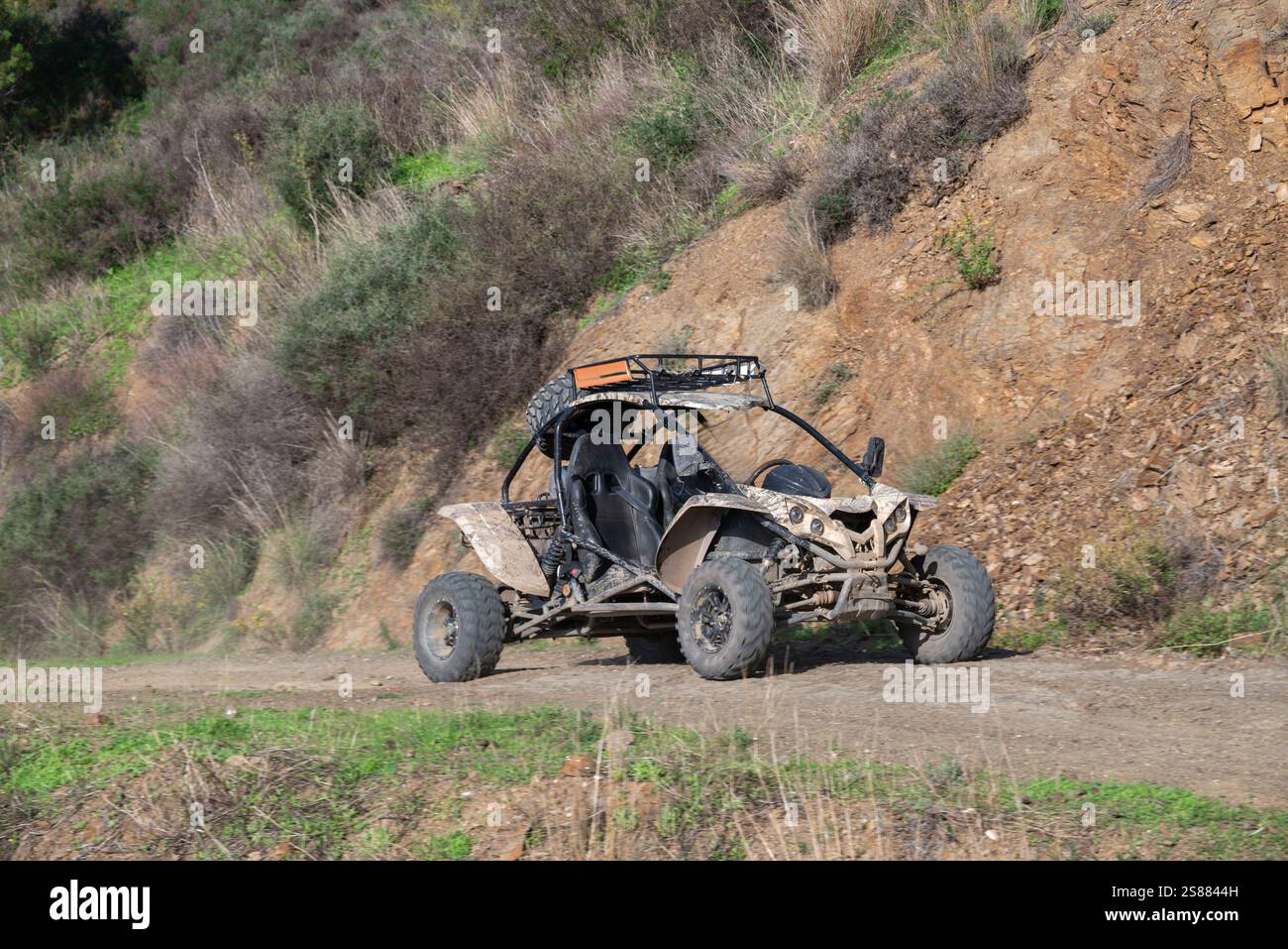 Off road buggy without driver on the road in a rocky and dry landscape ...