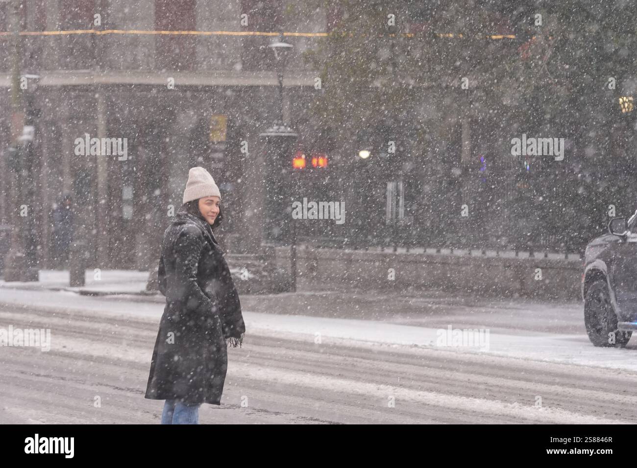 A person walks to Jackson Square as snow falls in the French Quarter in ...
