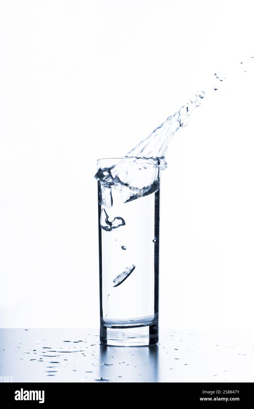 water splashing from glass isolated on white background Stock Photo - Alamy