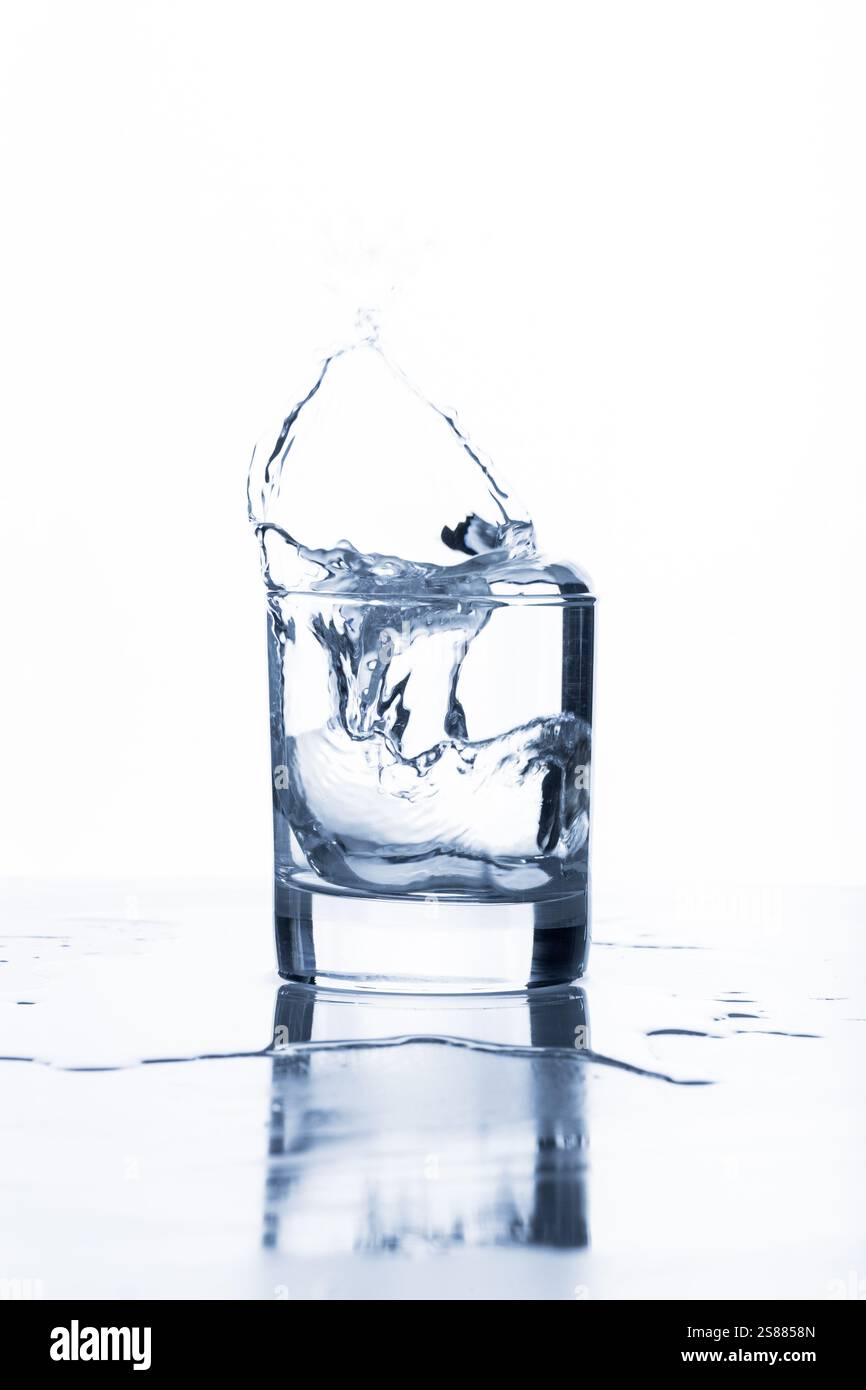 water splashing from glass isolated on white background Stock Photo - Alamy