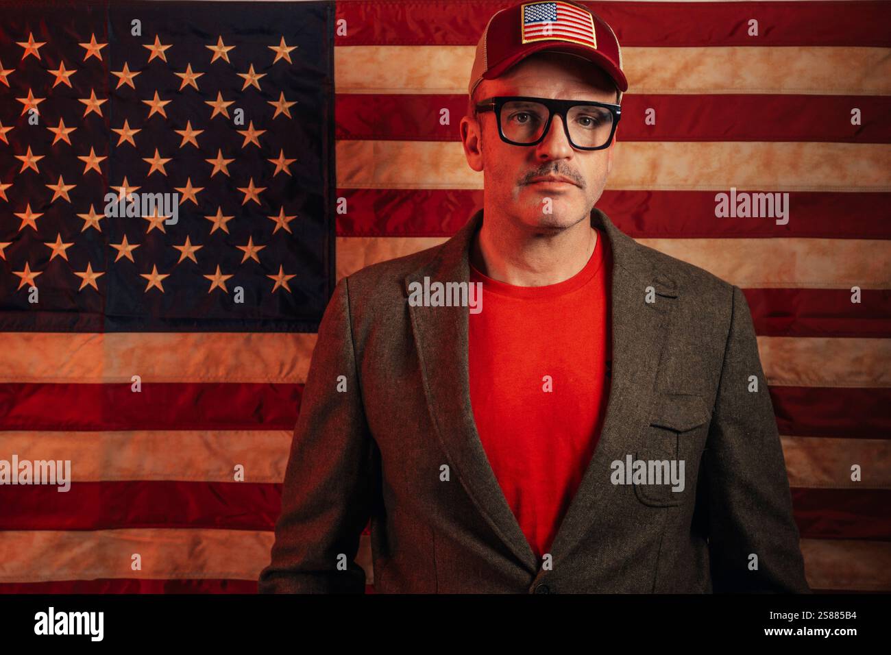 Confident man looking at camera, American flag background, patriotic ...