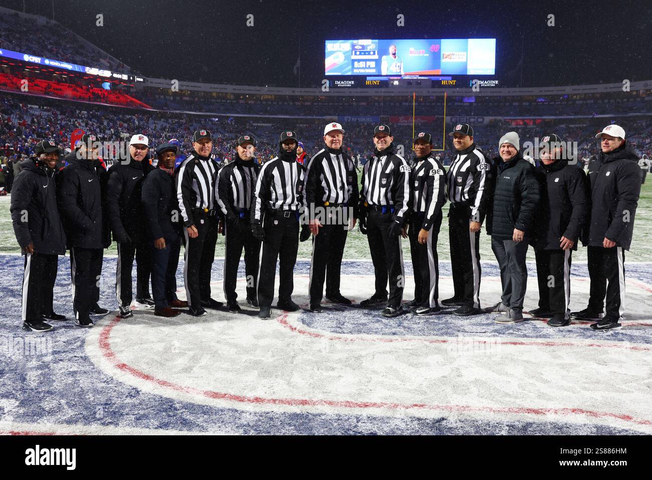 Uniformed Officials, from left to right, field judge Joe Blubaugh ...