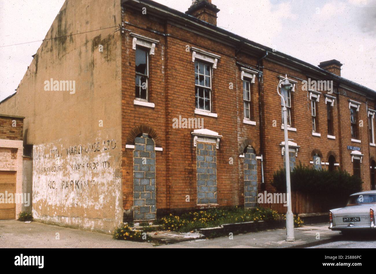 1970s, exterior, a boarded-up two-storey brick building, warehousing ...