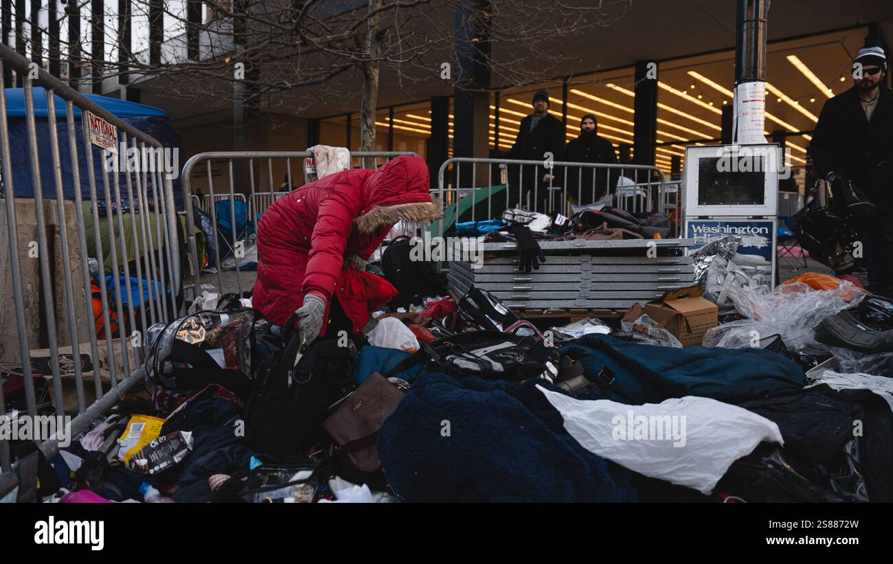A woman sifts through a pile of trash and debris outside the Capital ...