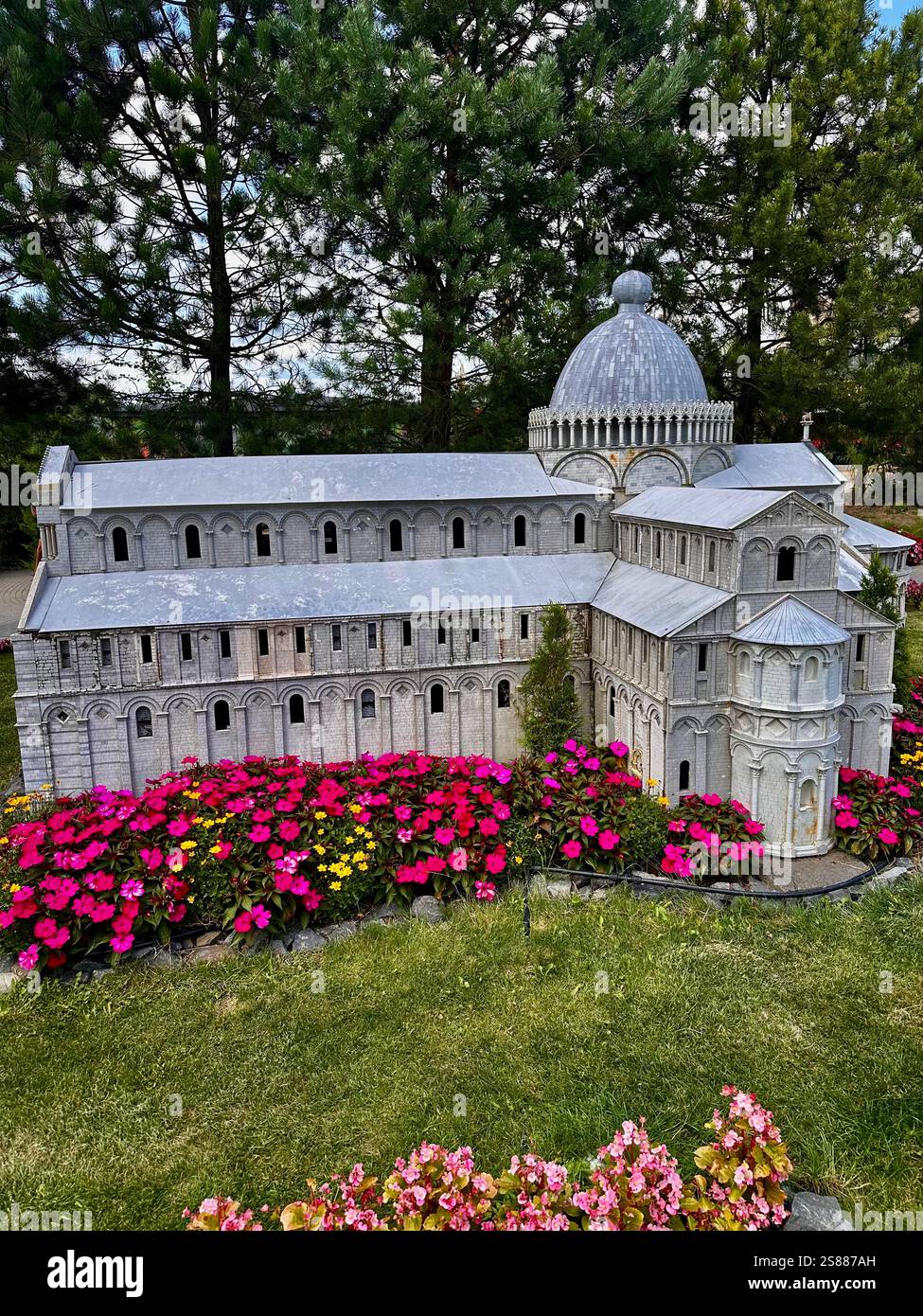 Miniature replicas of famous buildings surrounded by vibrant flowers ...