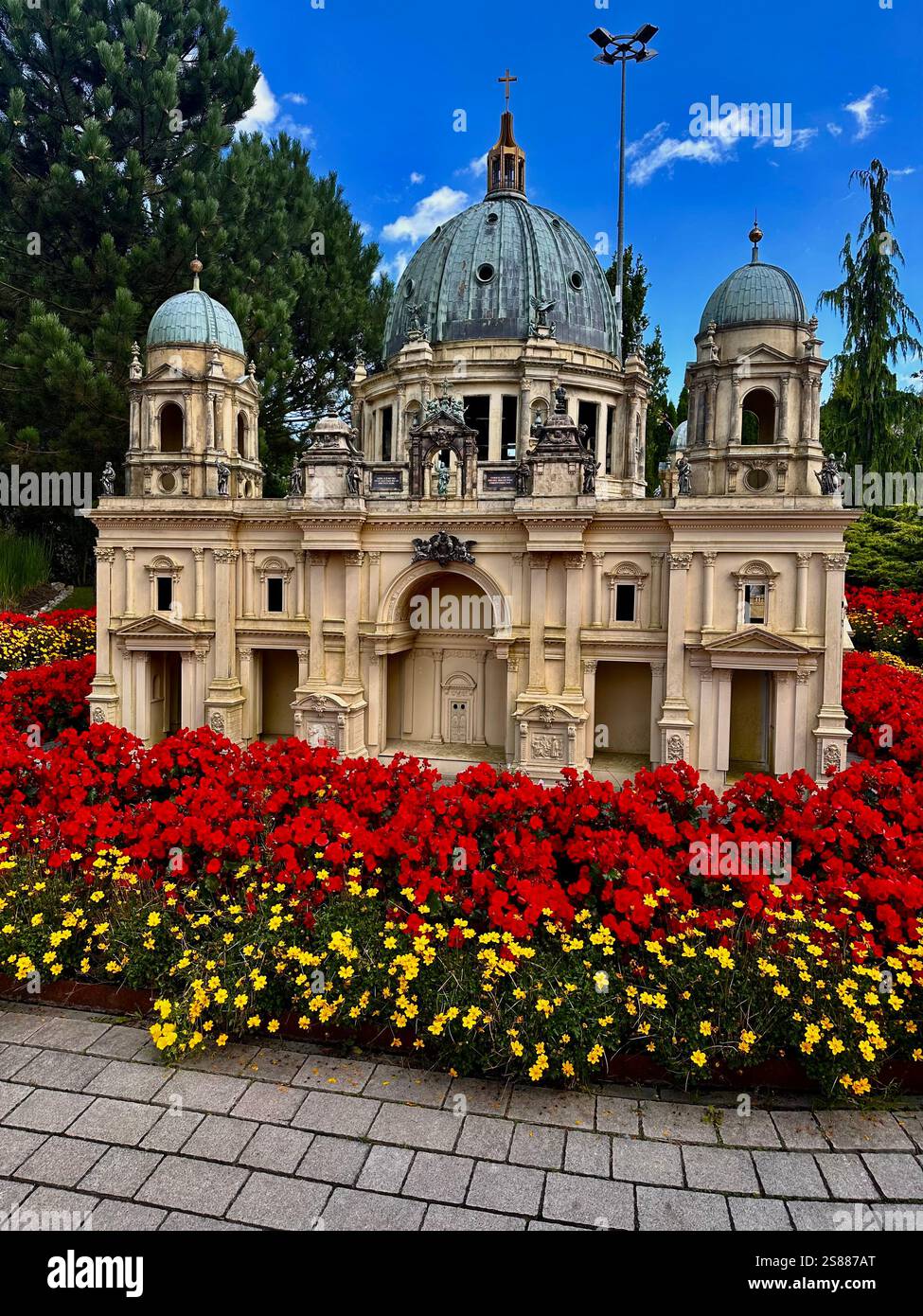 Miniature replicas of famous buildings surrounded by vibrant flowers ...