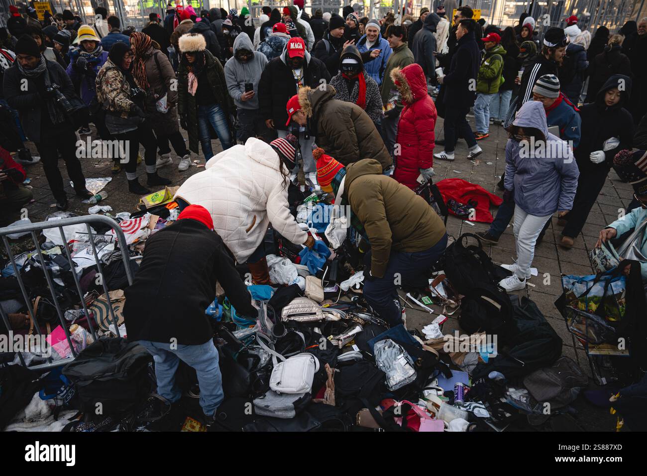Individuals sift through a pile of trash and debris outside the Capital ...