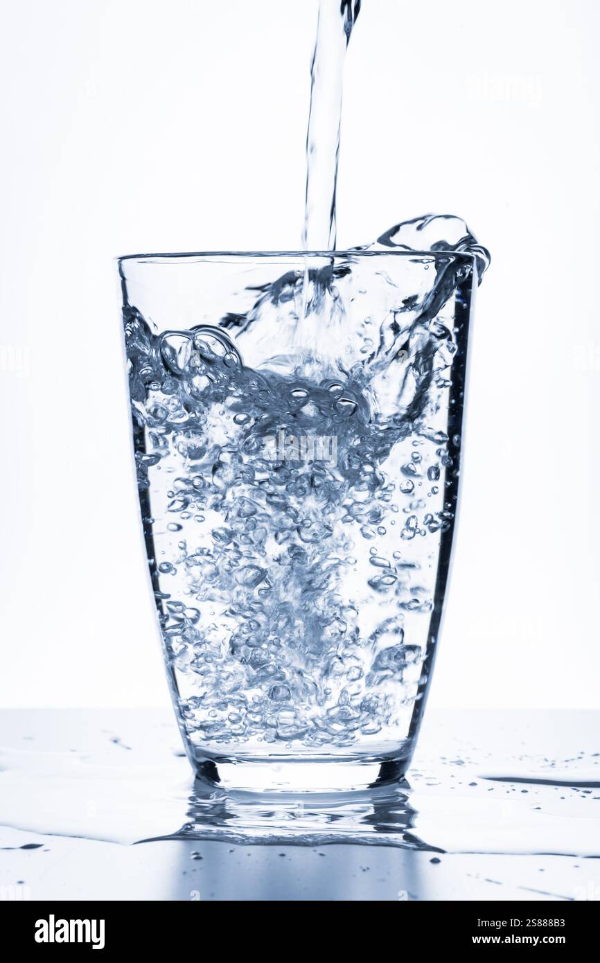 water splashing from glass isolated on white background Stock Photo - Alamy
