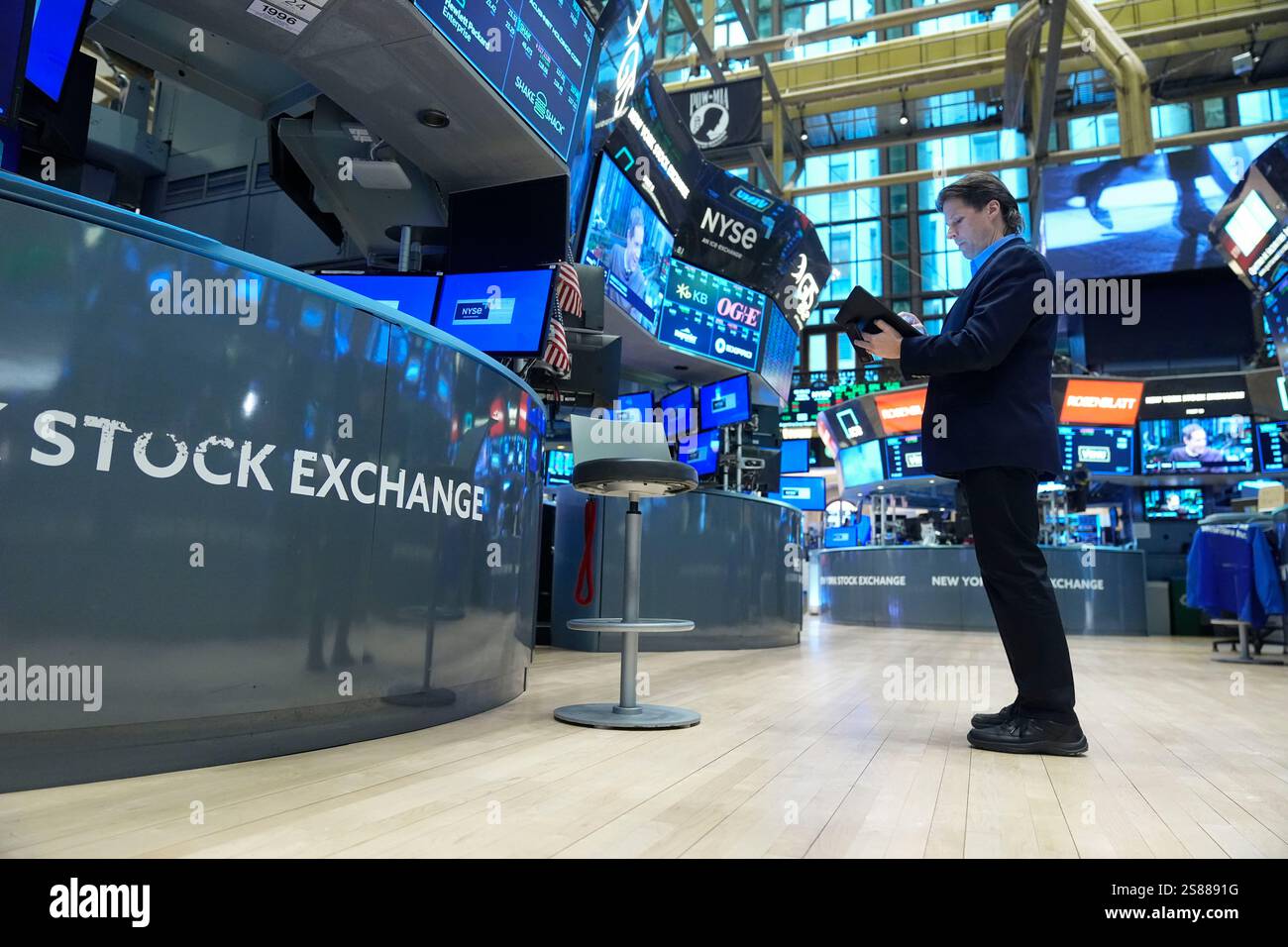 Traders work on the floor at the New York Stock Exchange in New York ...