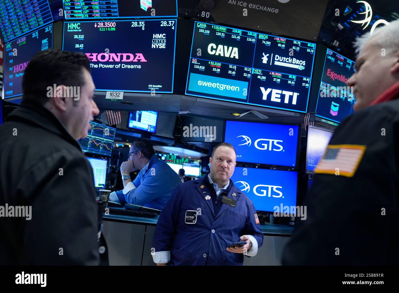 Traders work on the floor at the New York Stock Exchange in New York ...