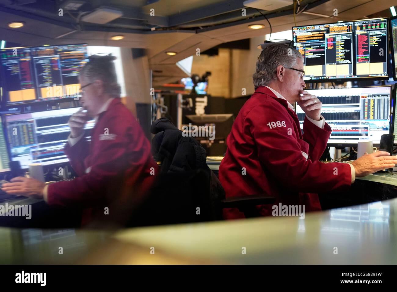 Traders work on the floor at the New York Stock Exchange in New York ...