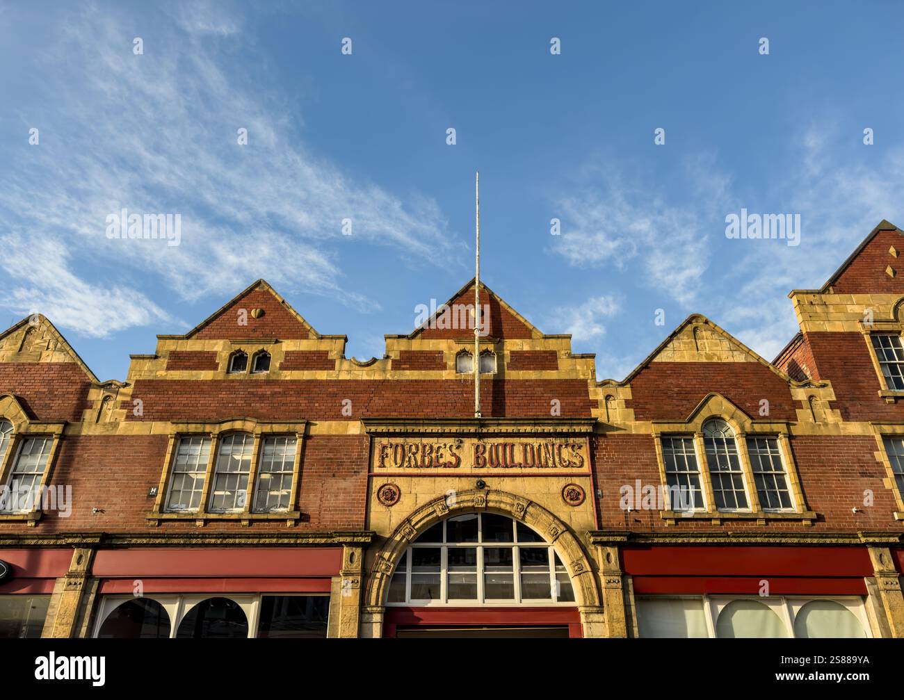 Forbes' Buildings exterior facade seen against a blue sky ...