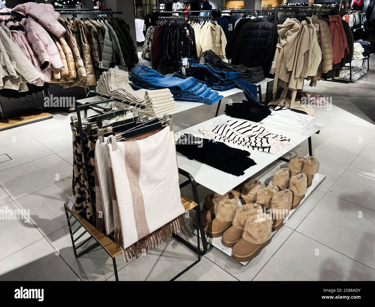 A cozy clothing store interior showcasing winter fashion, with jackets ...