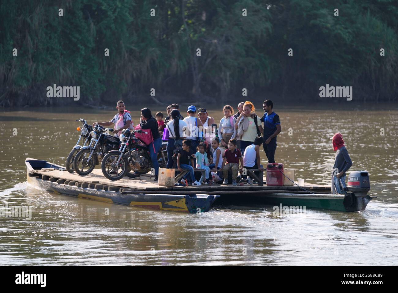 Residents cross a river to Venezuela from Colombia's Tibu, Tuesday, Jan ...