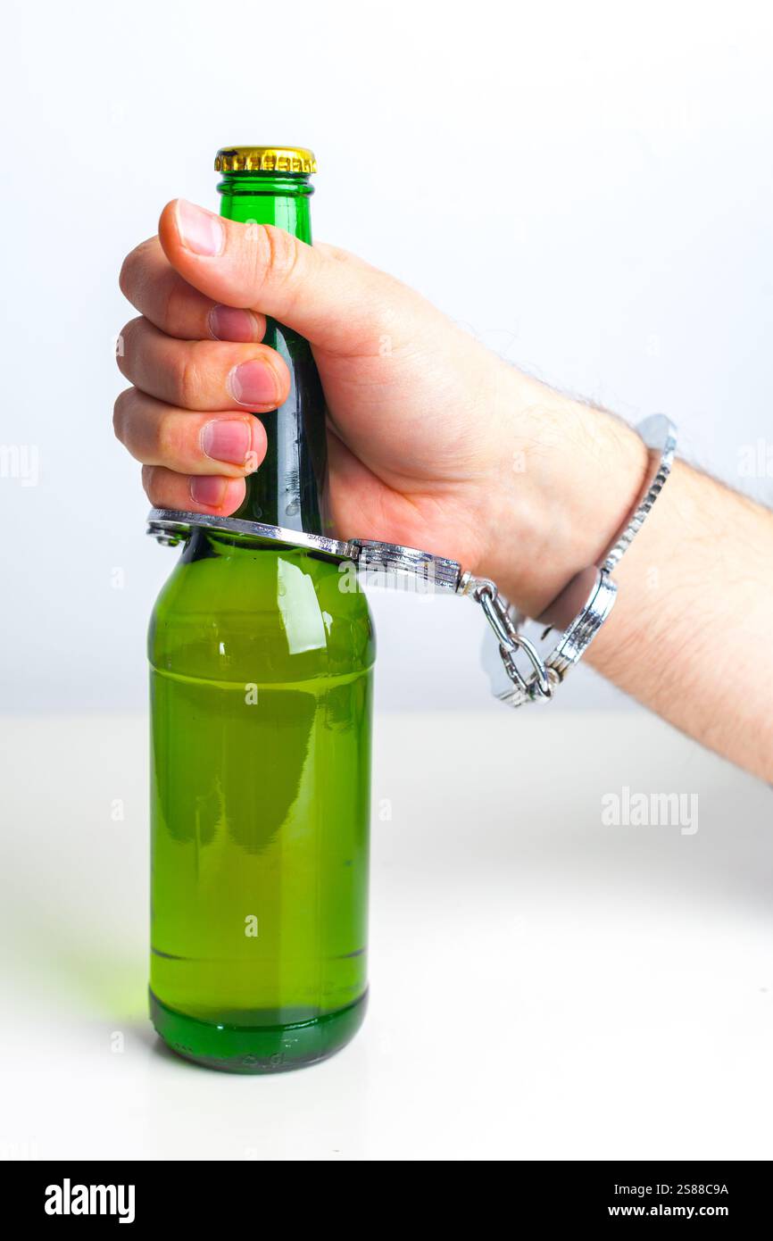 Glass of beer with handcuffs as symbol for alcohol abuse Stock Photo ...