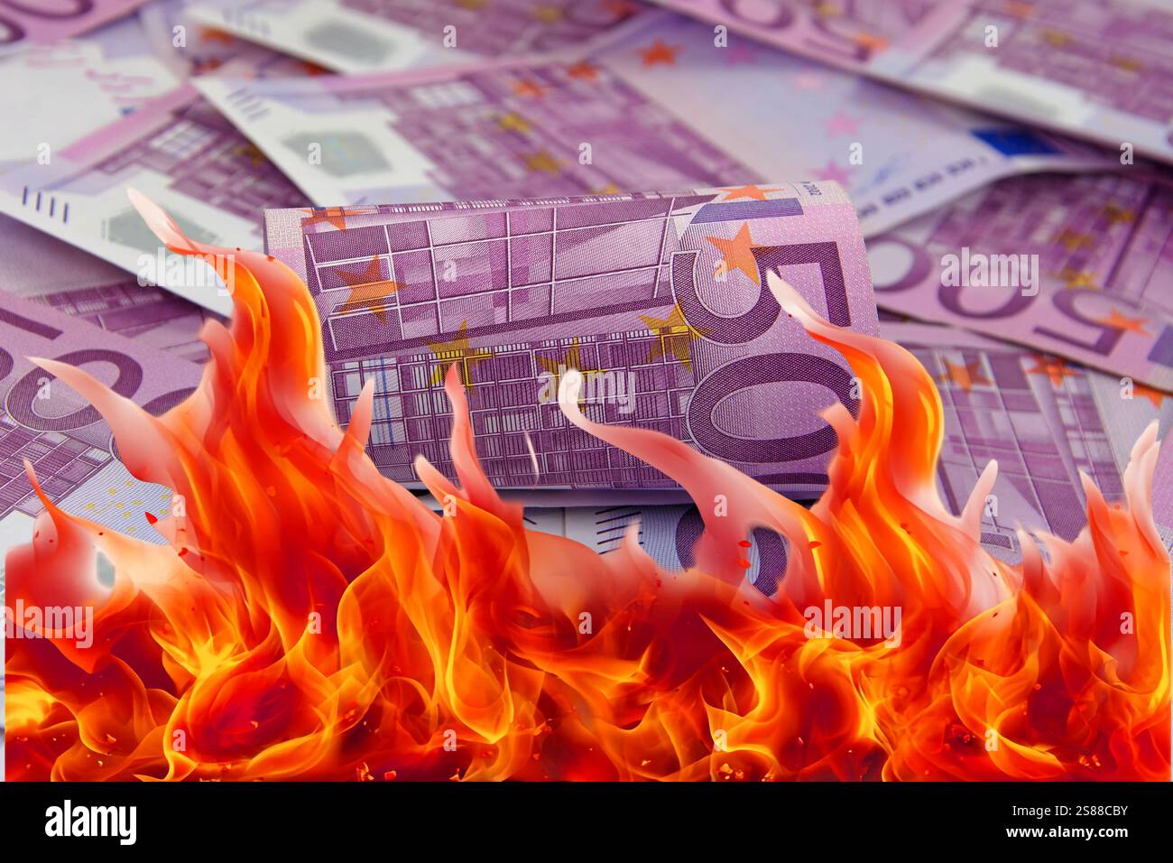 Burning money, wasting money in a symbolic representation Stock Photo ...