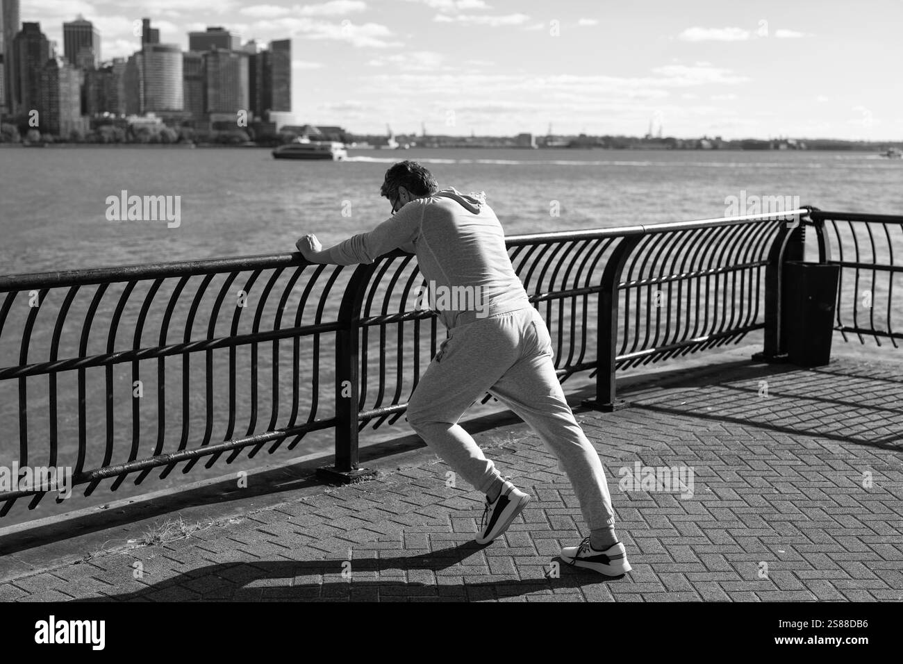 Sportsman stretching his muscles after running. Sportsman stretch to ...
