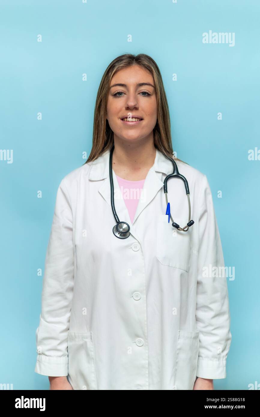 vertical Young female doctor wearing white lab coat and stethoscope ...