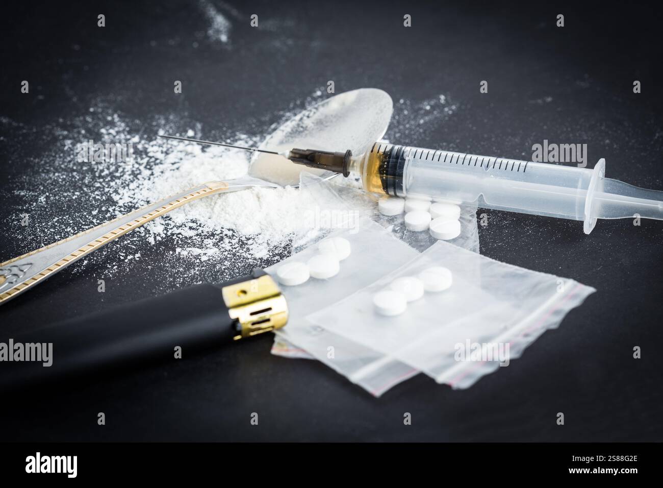 Drug syringe and cooked heroin on spoon Stock Photo - Alamy