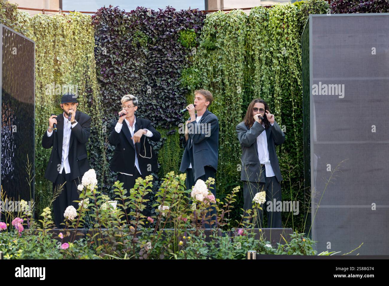 Moscow, Russia - August 25, 2024, A group of four young singers in ...
