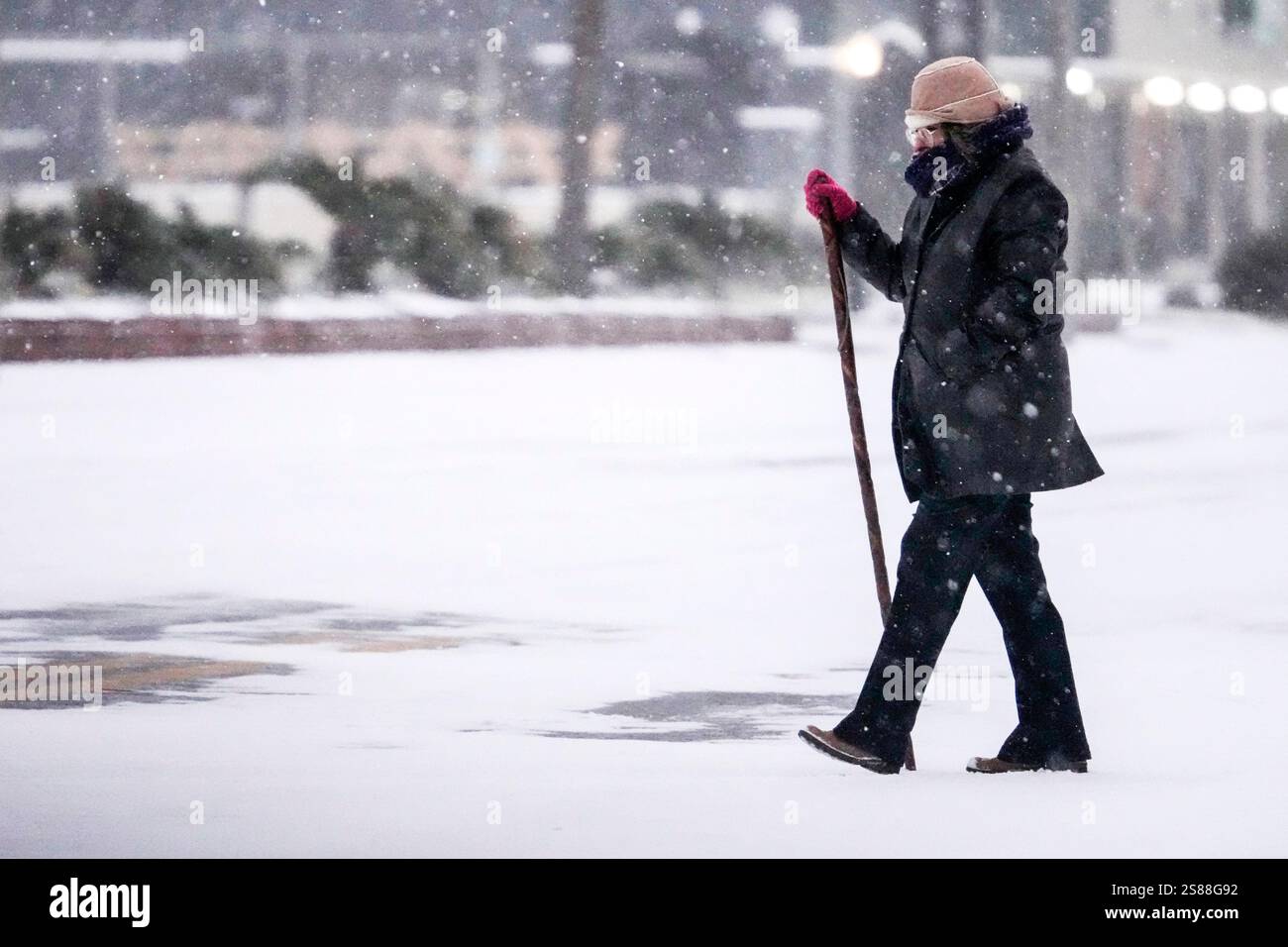 A woman walks in the snow during an icy winter storm on Tuesday, Jan ...
