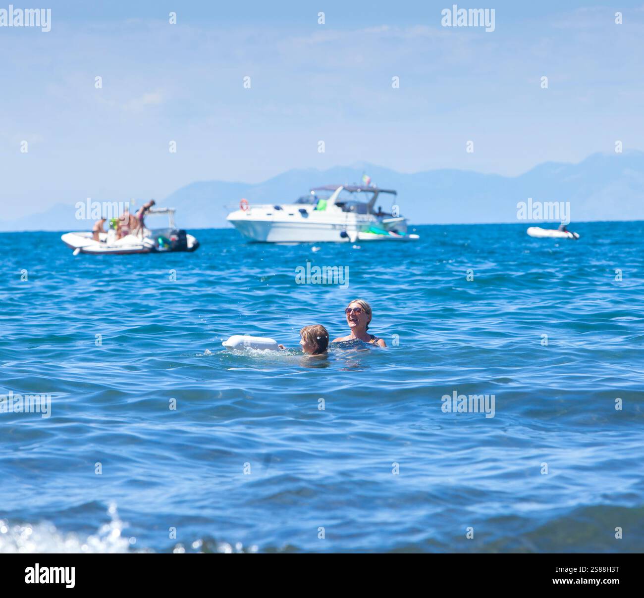 Mother and son bathing at Pozzo Vecchio, Procida, Italy Stock Photo - Alamy