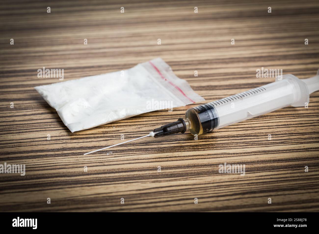 Drug syringe and cooked heroin Stock Photo - Alamy