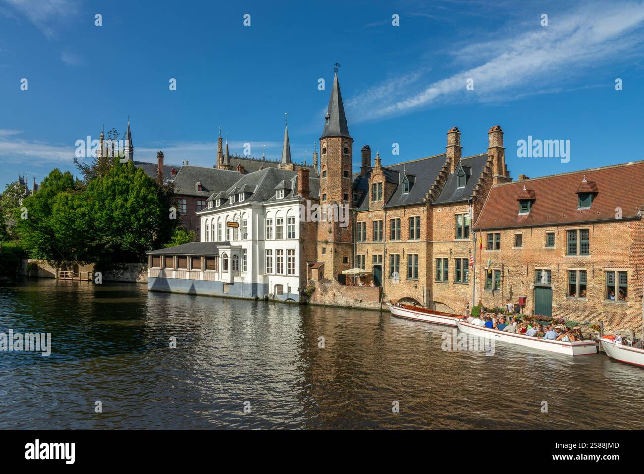 Tourists in a boat on a canal, touristic river boat tour in Bruges ...