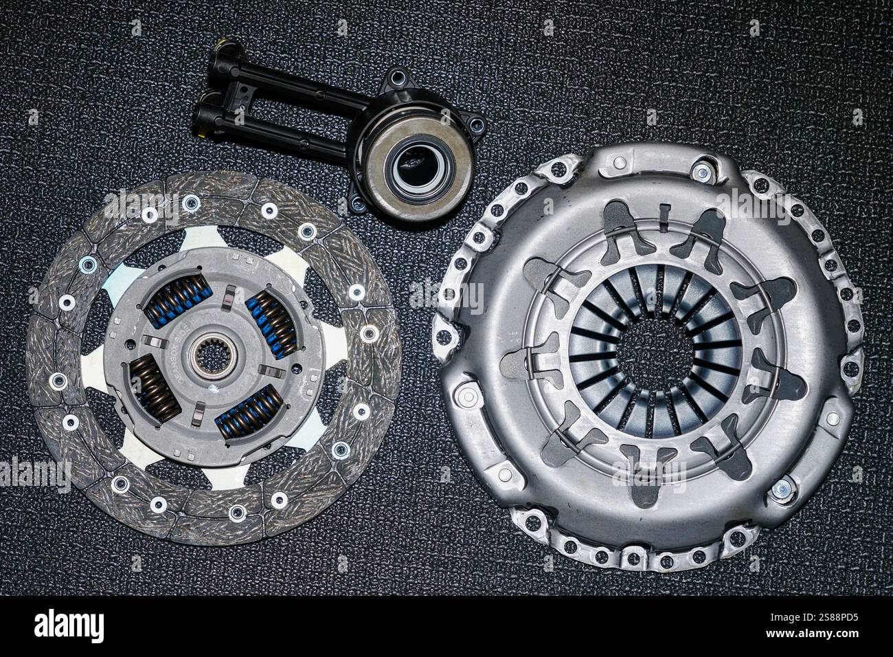 A new set of automotive clutch on a gray background, disc and clutch ...