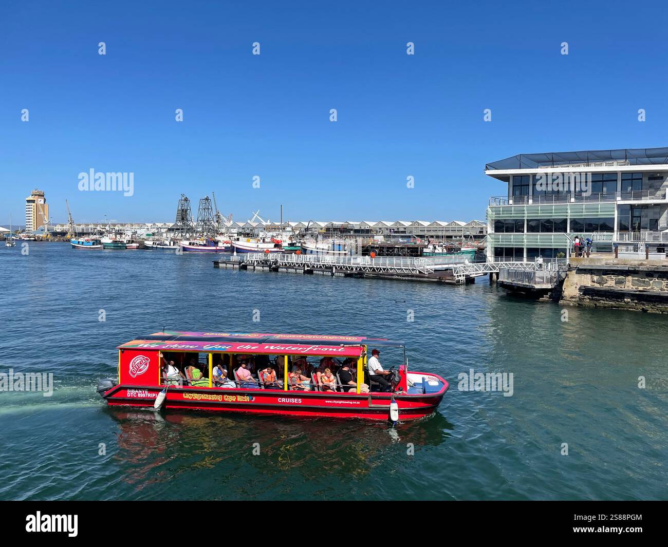 City sightseeing red hop on hop off canal cruise boat with people or ...