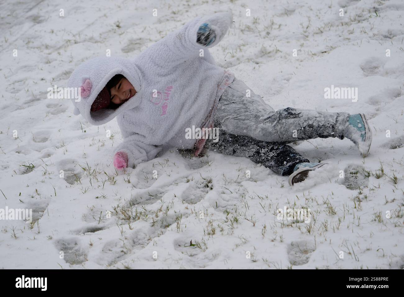 Mariella Rodriguez rolls around in snow Tuesday, Jan. 21, 2025, in ...