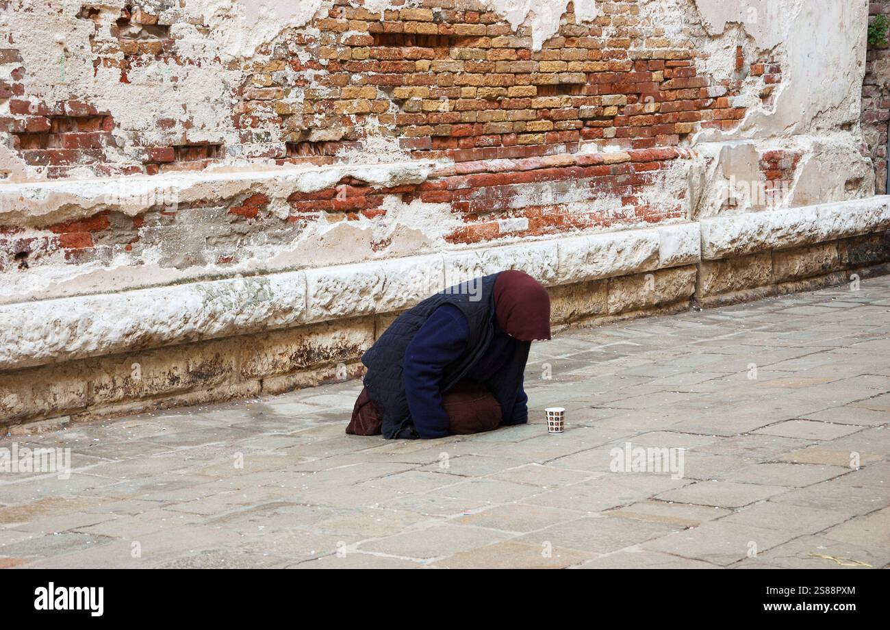 Woman begging in Venice, Italy. Homelessness, poverty, social problems ...