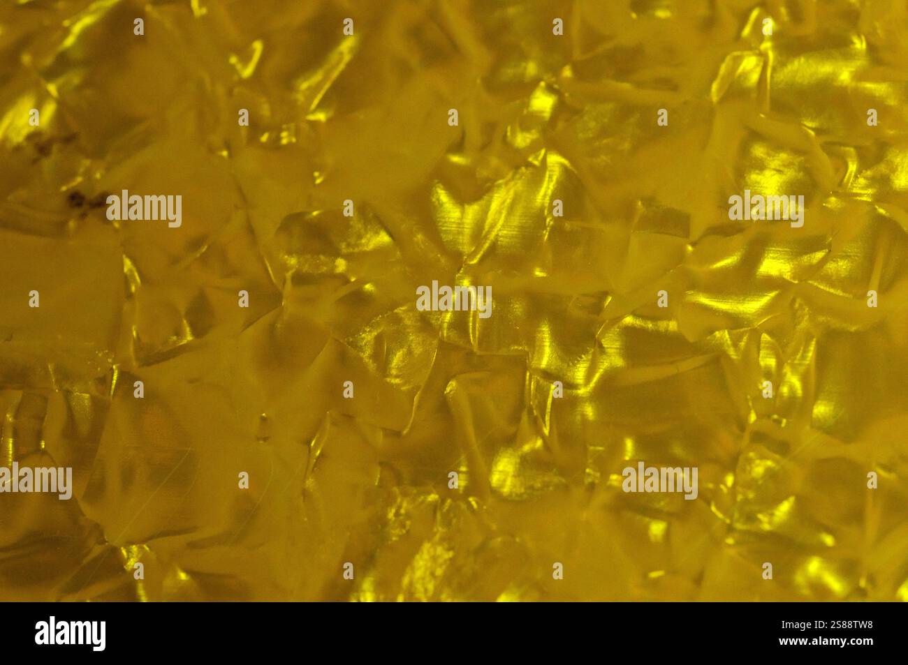 The image shows a close-up view of a textured, gold-colored surface ...