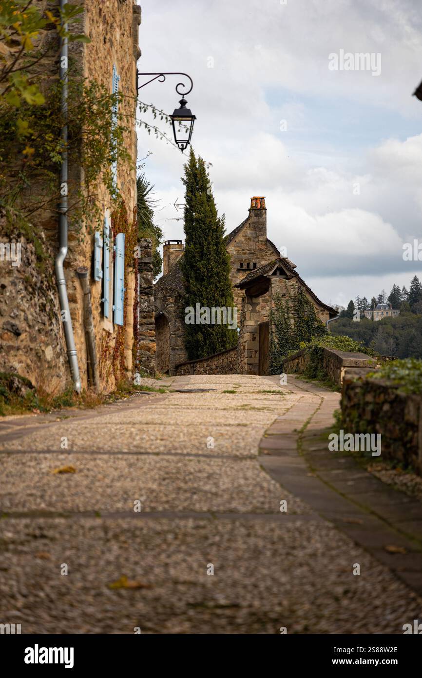 Charming view of a stone pathway in the medieval village of Najac ...