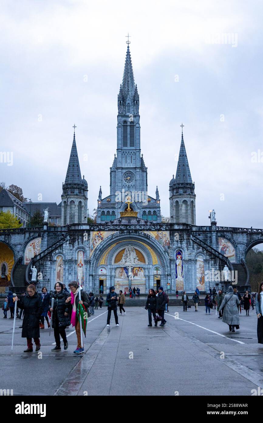 Vertical majestic view of the Sanctuary of Our Lady of Lourdes in Lourdes, France, featuring the ...