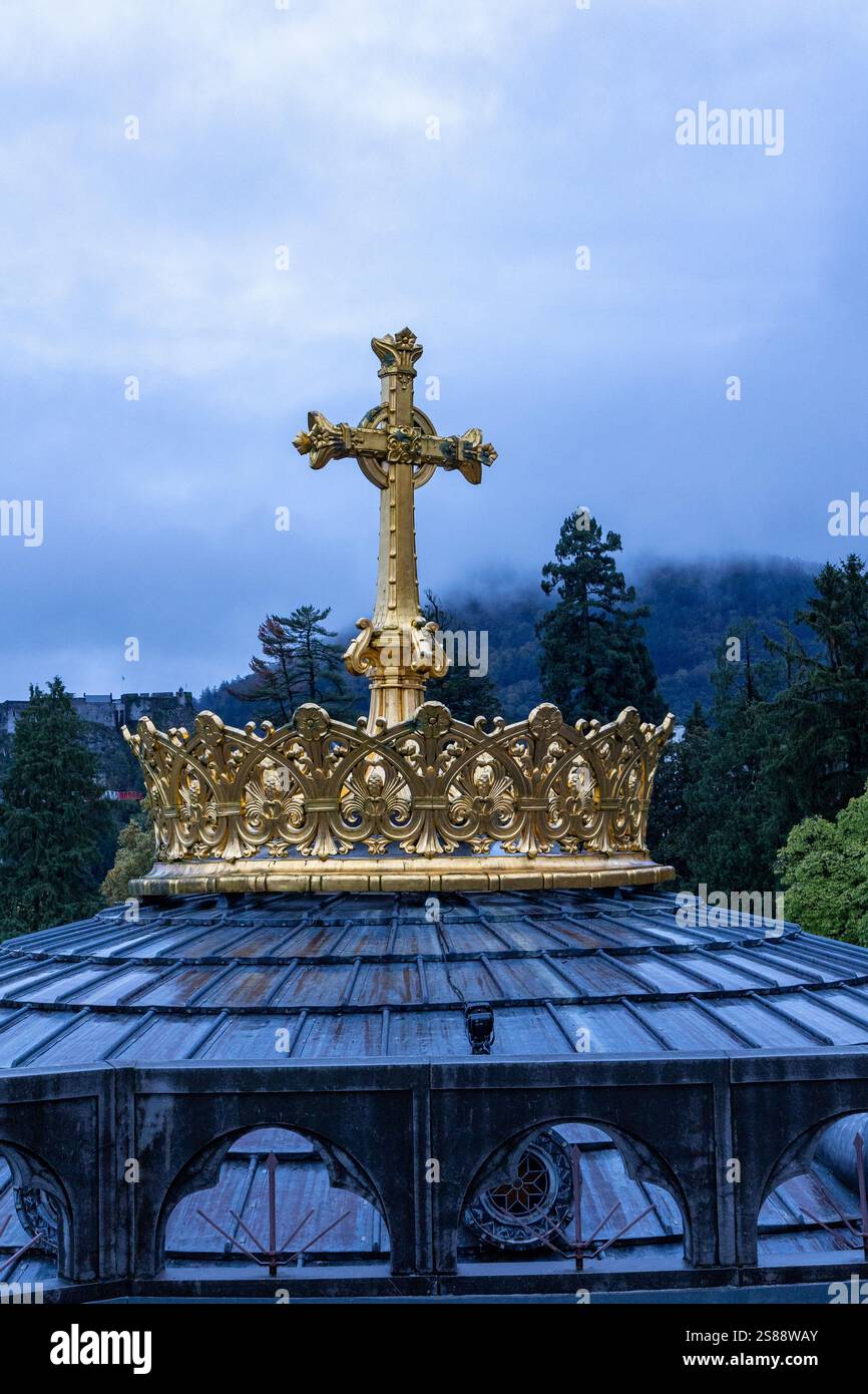 Detailed view of the ornate golden crown and cross adorning the dome of ...