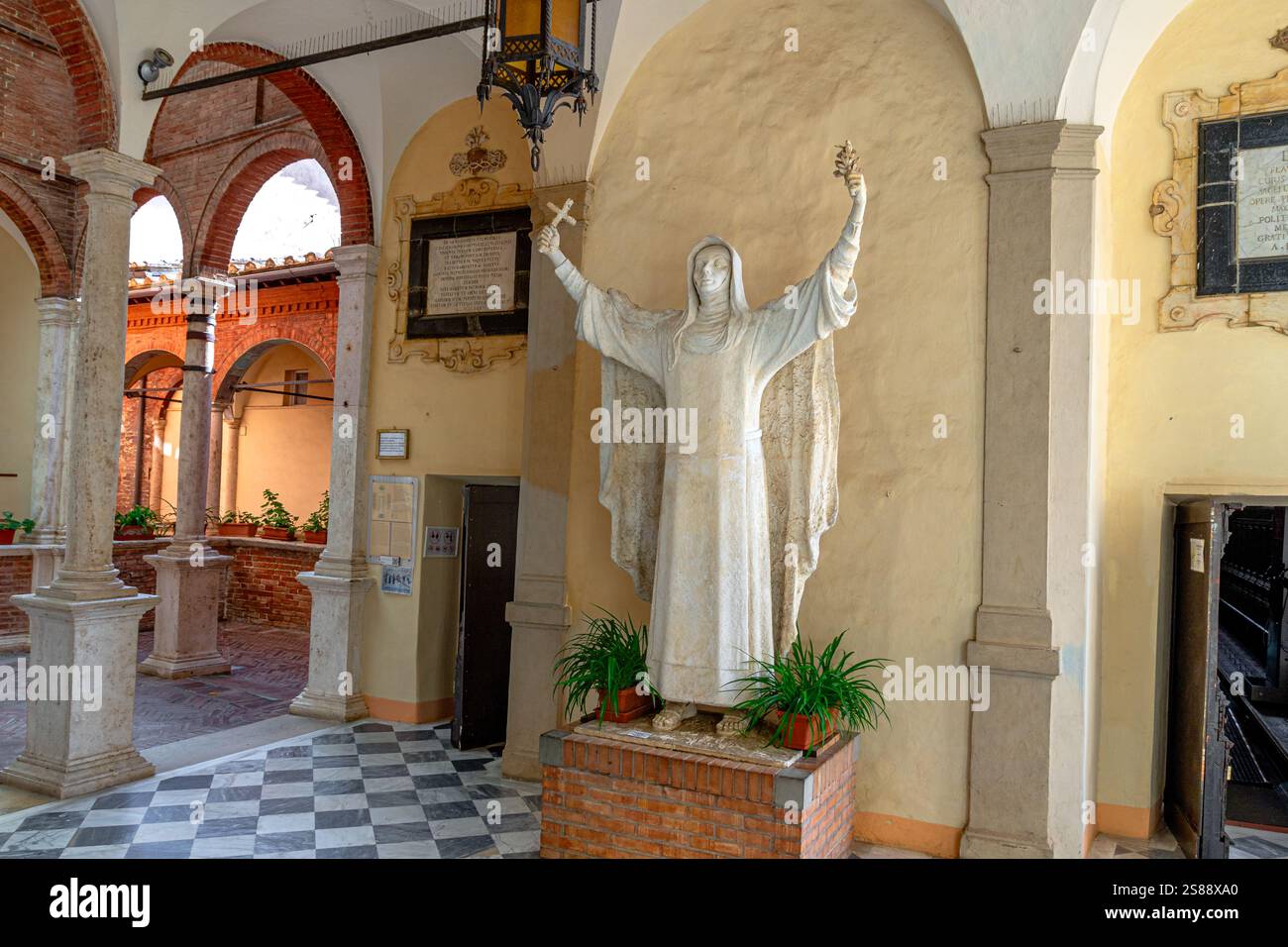 A statue of St Catherine stands in the cloisters of The Sanctuary Of St ...