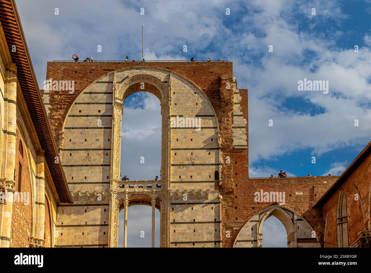 People at the The Facciatone of Siena , the remains of the New ...