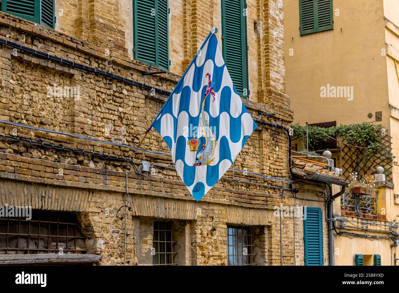 The flag of the Contrada Onda , Wave Contrada hanging from the wall of ...