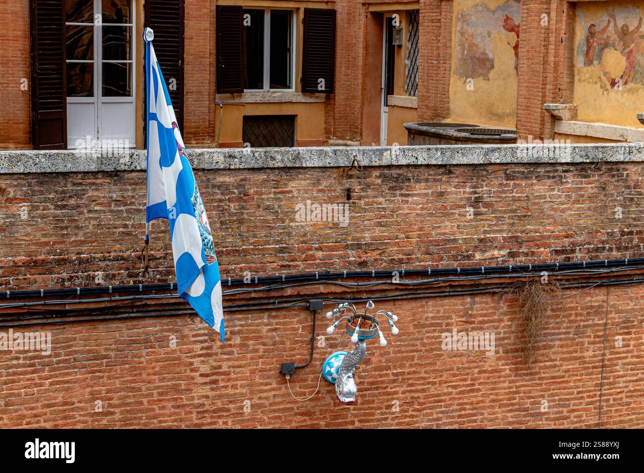 The flag of the Contrada Onda , Wave Contrada hanging from the wall of ...