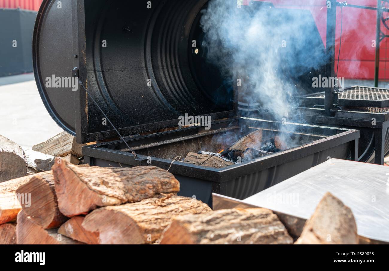 roasting hot dogs over campfire pit and grill, smoke bbq and pile of ...