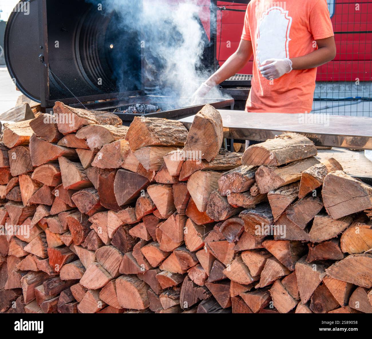 roasting hot dogs over campfire pit and grill, smoke bbq and pile of ...