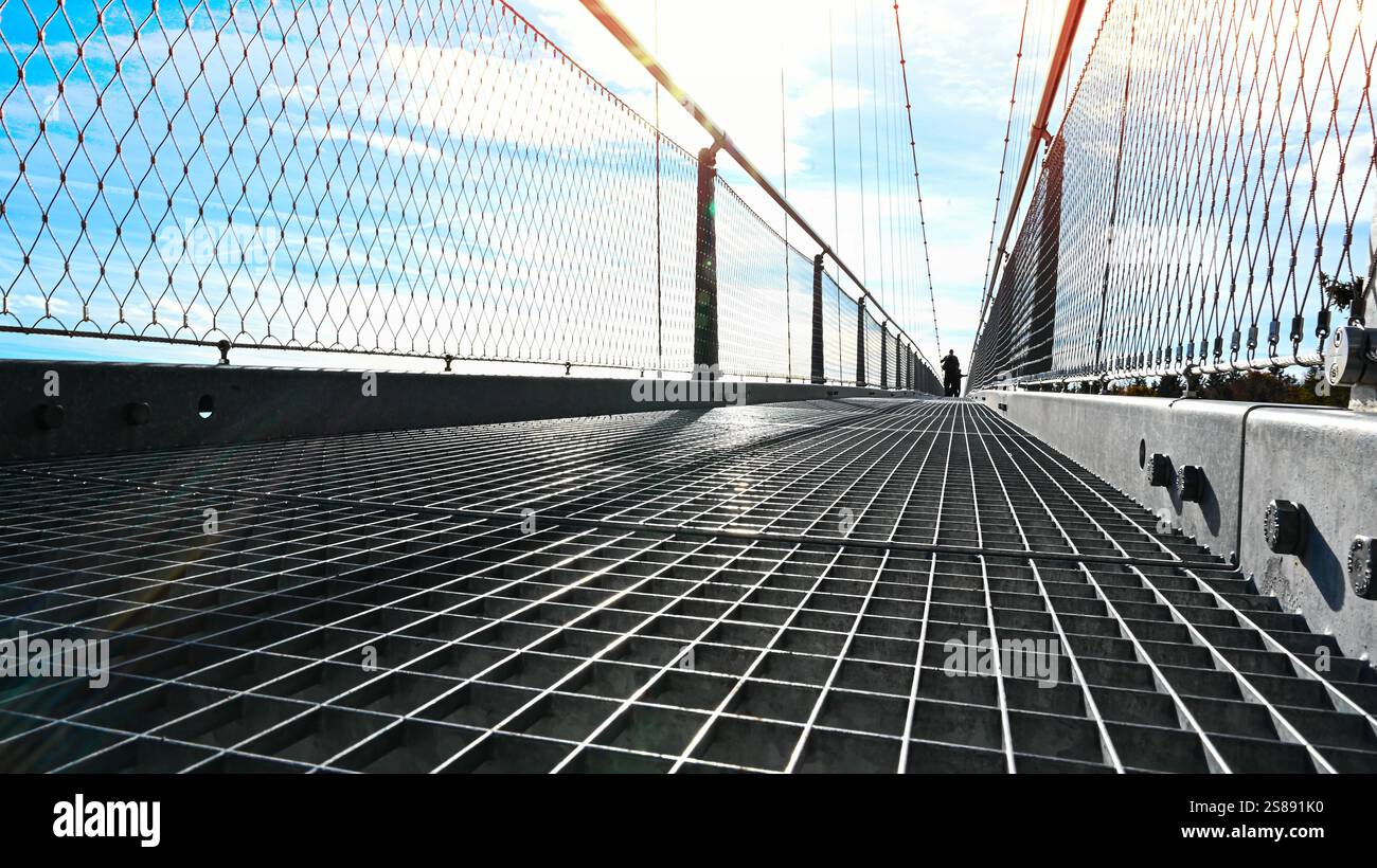 A modern pedestrian bridge with steel cable construction Stock Photo ...