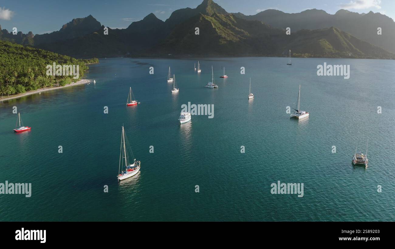 Sailboats yachts and catamarans anchoring stop near tropical island ...