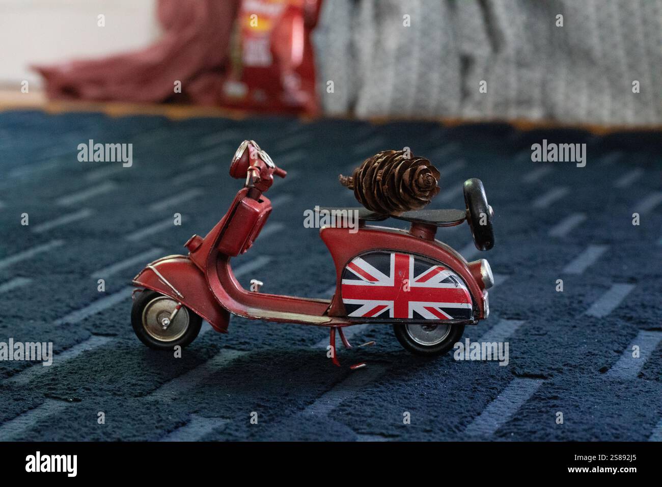 Toy scooter, pine cone, UK flag Stock Photo - Alamy