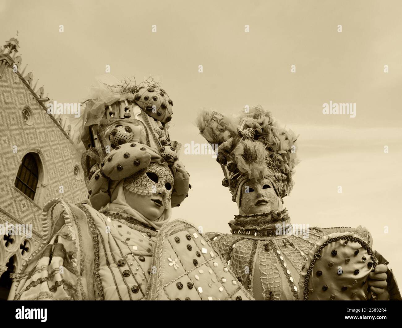 Two noble masks with Doge's Palace at background. St Mark's Square ...