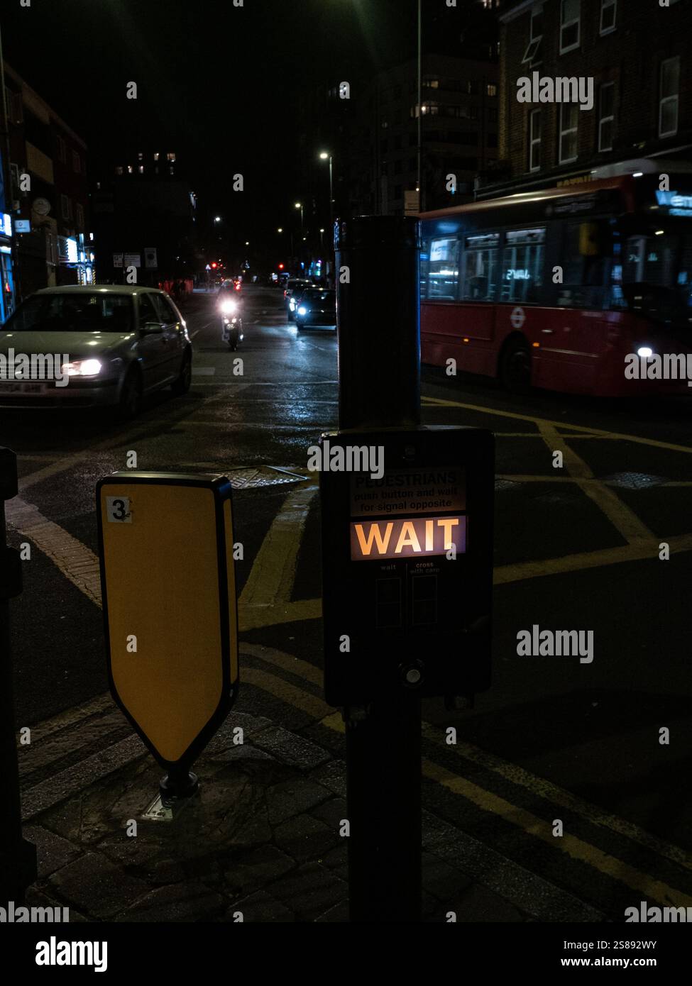 Pedestrians wait, signal shows WAIT Stock Photo - Alamy