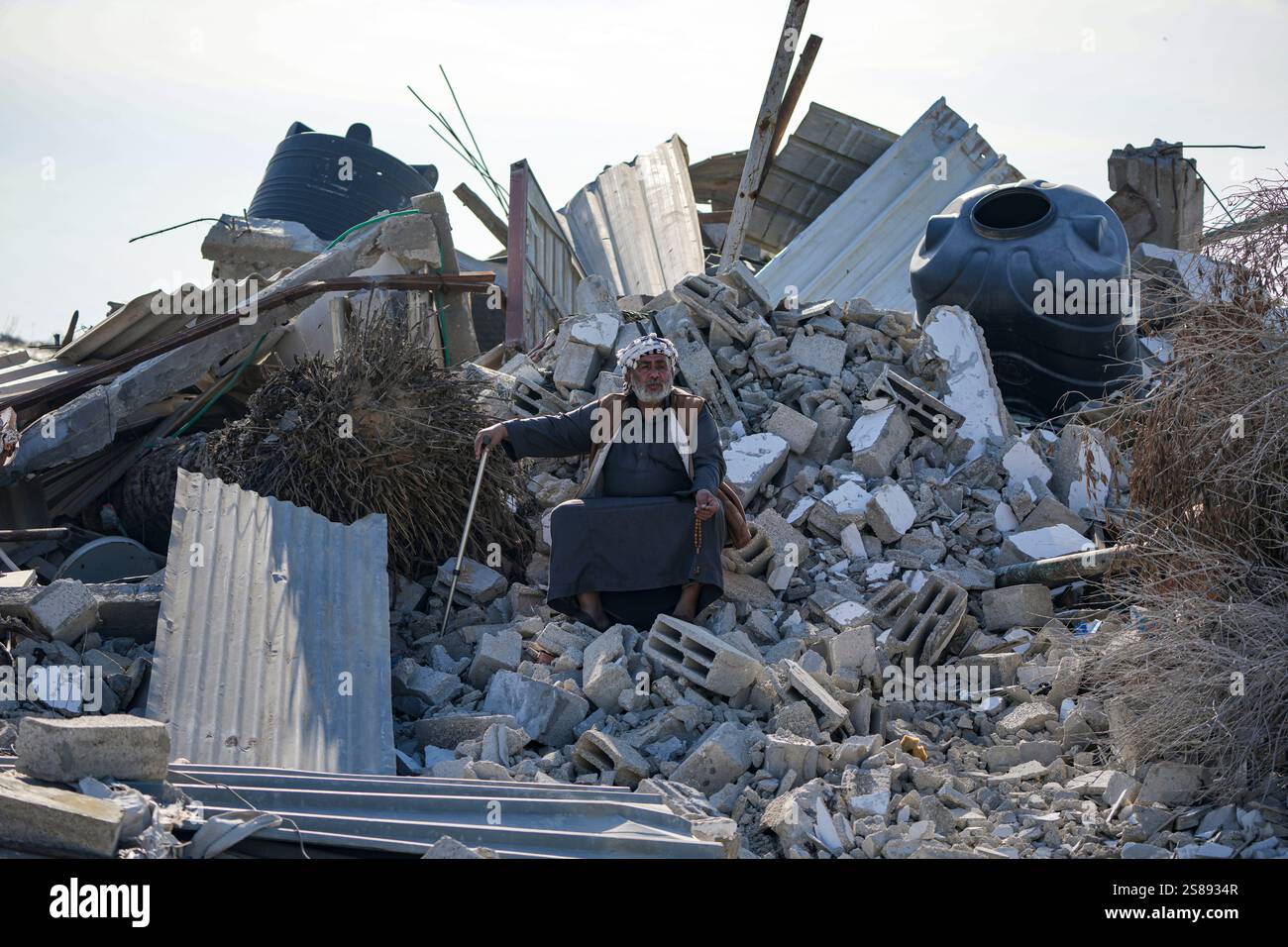Atiya Abu Sheiban sits on the ruins of his destroyed home, days after ...