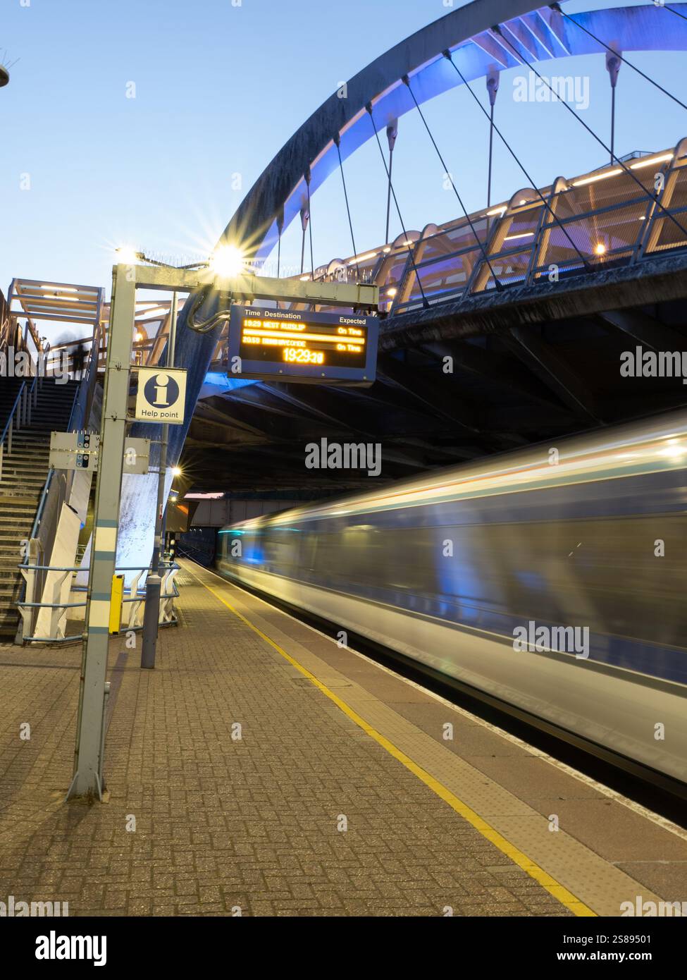 Train arrives, platform, schedule shown Stock Photo - Alamy