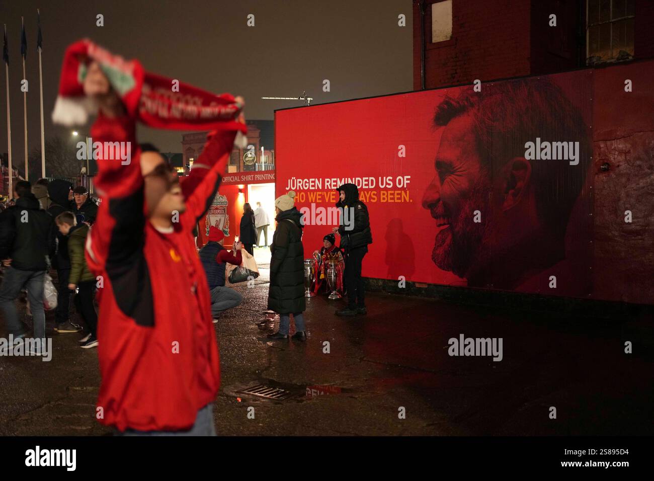 Spectators take picture next to a billboard of Jurgen Klopp prior to ...